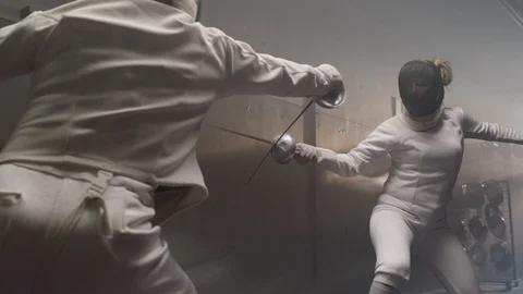 Female fencer parry and riposte in a dar... | Stock Video | Pond5