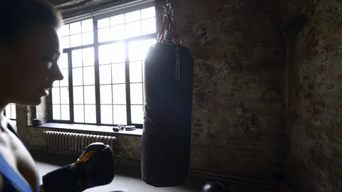 Female fighter boxing in dark gym | Stock Video | Pond5