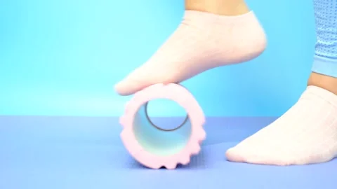 Female foot rolls a massage foam roller ... | Stock Video | Pond5