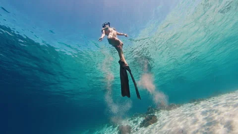 Female freediver swims in the tropical s... | Stock Video | Pond5
