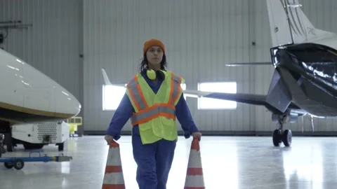 Female ground crew worker carrying safet... | Stock Video | Pond5