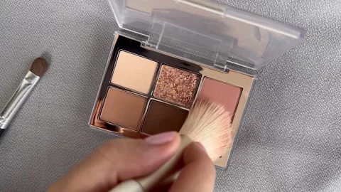 female hand applying pink blush on a bru... | Stock Video | Pond5