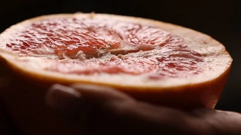 Female hand close-up crushes grapefruit ... | Stock Video | Pond5
