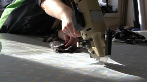 Female Hand Cutting Fabrics Using Machin... | Stock Video | Pond5