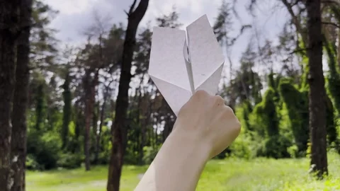 Female hand playing with paper airplane ... | Stock Video | Pond5
