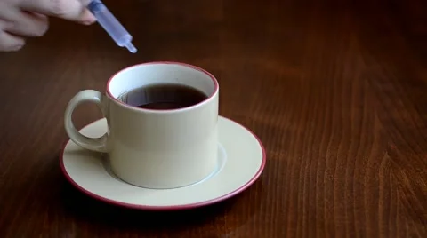 Female hand poisoning tea with syringe | Stock Video | Pond5