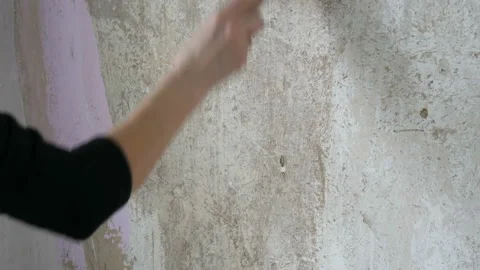 A female hand smears wallpaper glue on t... | Stock Video | Pond5
