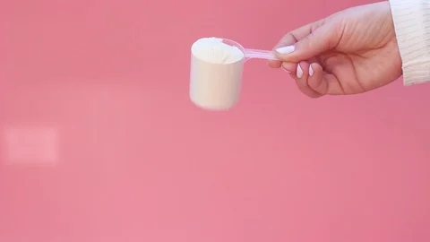 Female hand spills protein from a measur... | Stock Video | Pond5