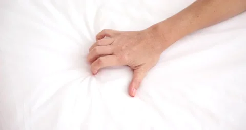 Female hand squeezing sheet during orgas... | Stock Video | Pond5