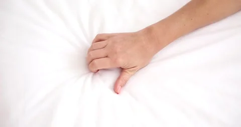 Female hand squeezing sheet during orgas... | Stock Video | Pond5