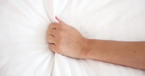 Female hand squeezing white sheet during... | Stock Video | Pond5