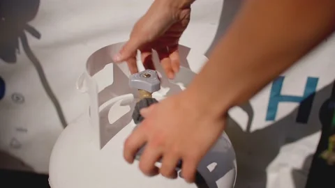 Female hand turning propane nozzle | Stock Video | Pond5