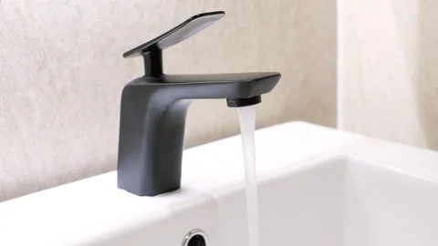 Female hand turns on water in the tap in... | Stock Video | Pond5