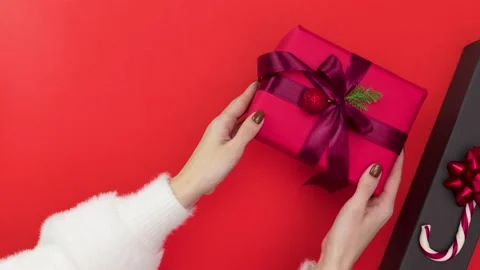 Female hands fold christmas gifts on the... | Stock Video | Pond5