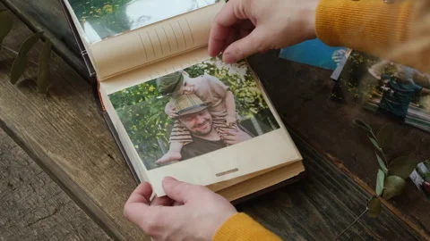 Female hands inserting printed photo of ... | Stock Video | Pond5