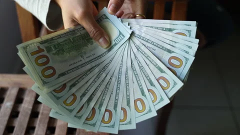 Female hands showing a handful of 100 do... | Stock Video | Pond5