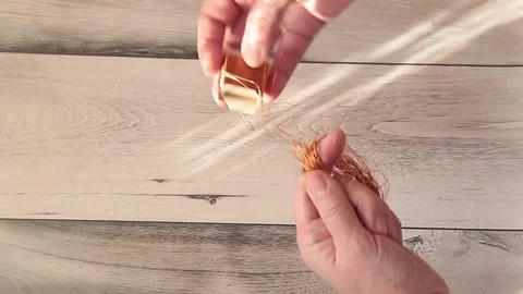 Female hands wind hands wind a copper wi... | Stock Video | Pond5