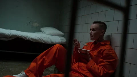 Female Inmate Eating in Prison Cell | Stock Video | Pond5