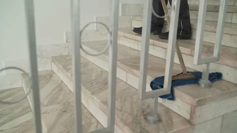 Female janitor mopping the stairs in the... | Stock Video | Pond5