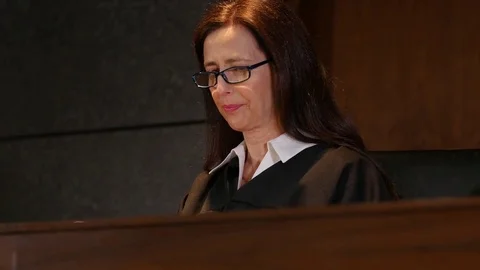 Female Judge doing research on the bench... | Stock Video | Pond5