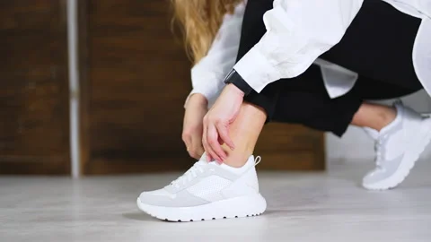 Female model demonstrates new white snea... | Stock Video | Pond5