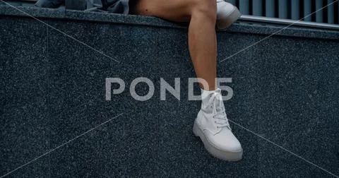 Female model legs sit posing in urban building city downtown. ~ Hi Res ...