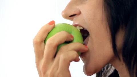 Female mouth eating apple, close-up, iso... | Stock Video | Pond5