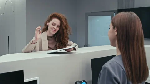 Female Patient Signing Document At Recep... | Stock Video | Pond5