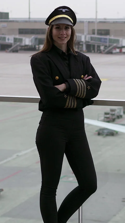 A Female Pilot Dressed in Uniform at the... | Stock Video | Pond5