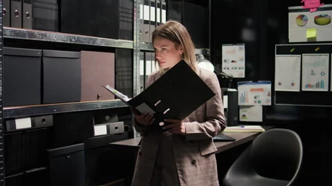 Female police officer examines paperwork | Stock Video | Pond5