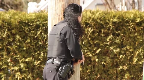 Female police officer with gun hiding be... | Stock Video | Pond5