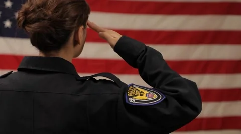 Female Police Officer Saluting Flag | Stock Video | Pond5
