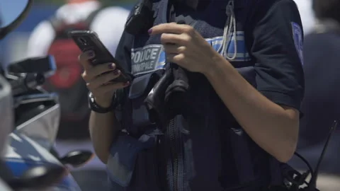 Female police officer using mobile phone... | Stock Video | Pond5