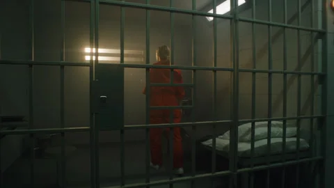 Female prisoner walks in jail cell, look... | Stock Video | Pond5
