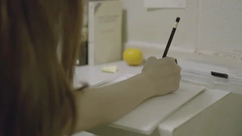 A female prisoner is writing a letter in... | Stock Video | Pond5