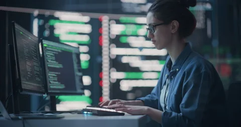 Female Programmer Writing Code Surrounde... | Stock Video | Pond5