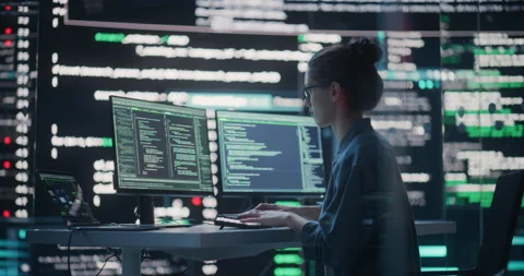 Female Programmer Writing Code Surrounde... | Stock Video | Pond5