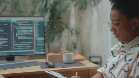 Female Programmer Writing Notes and Spea... | Stock Video | Pond5