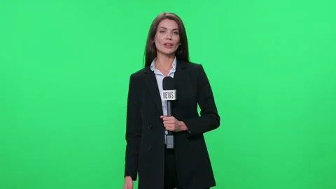 Female reporter in suit looks at the cam... | Stock Video | Pond5