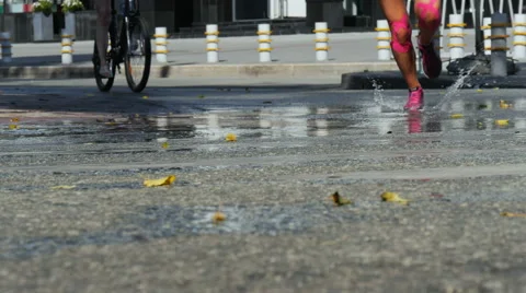 female runners ran through puddles of wa... | Stock Video | Pond5