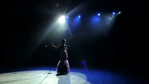 Female singer on the stage holding a mic... | Stock Video | Pond5