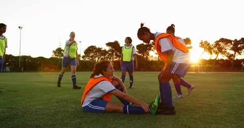 Female soccer player helping teammate to... | Stock Video | Pond5
