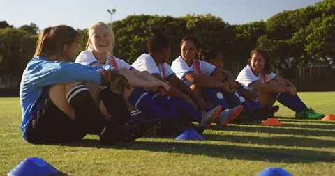 Female soccer team sitting on the ground... | Stock Video | Pond5