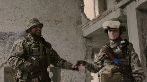 A female soldier gives a high five to he... | Stock Video | Pond5