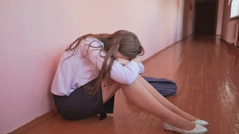 A female student is crying on the floor ... | Stock Video | Pond5