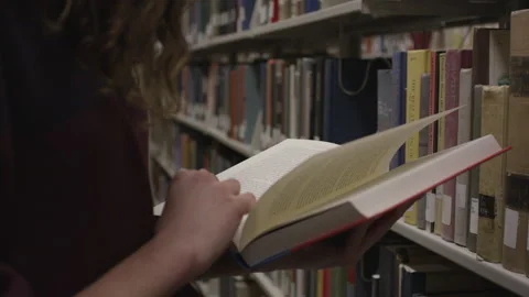 Female Student Flipping Through Book Pag... | Stock Video | Pond5