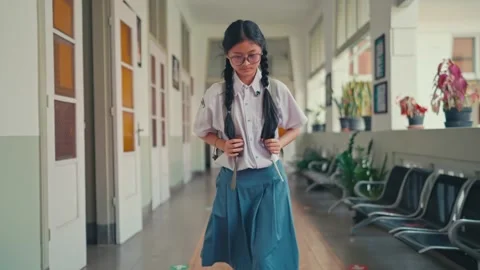 a female student walking alone in the sc... | Stock Video | Pond5