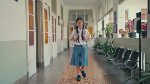a female student walking alone in the sc... | Stock Video | Pond5