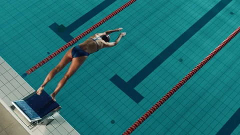Female swimmer Jumps into Pool High Shot | Stock Video | Pond5