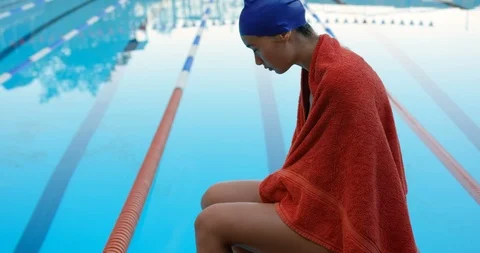 Female swimmer sitting near swimming poo... | Stock Video | Pond5